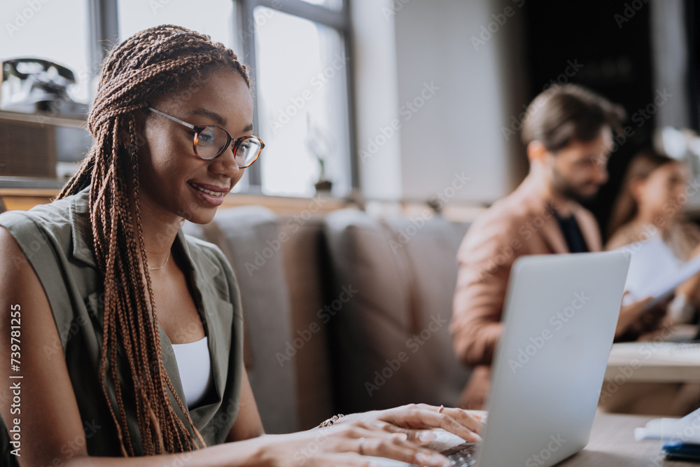 Beautiful businesswoman working on laptop in modern office. Group of ...