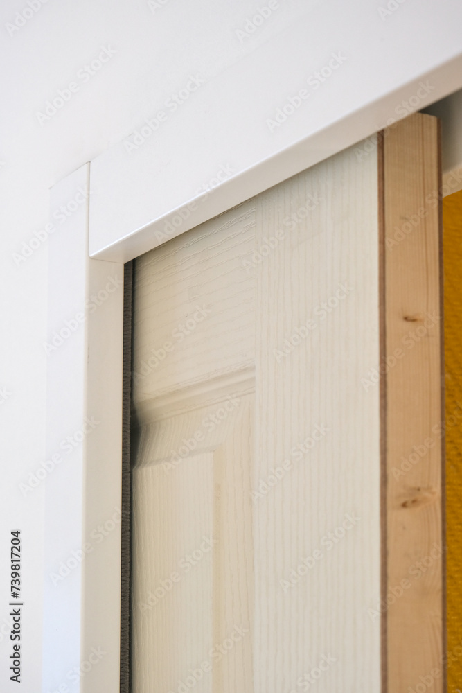 Pocket door in a white plasterboard wall (sliding door inside a wall ...