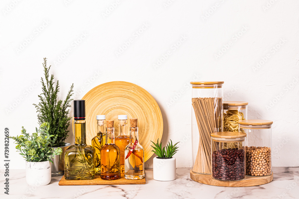 Many different bottles of natural cooking oil and jars for storing bulk ...
