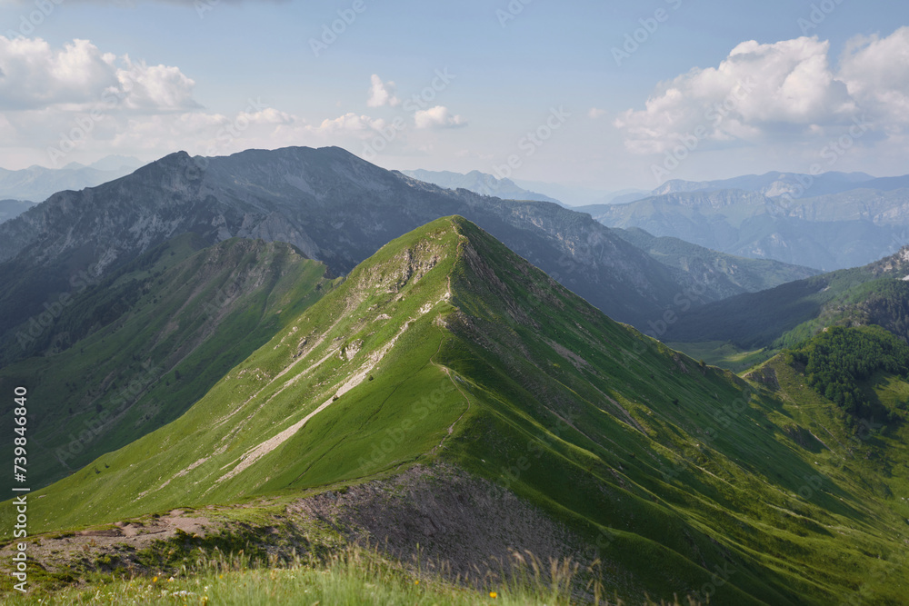 Summit ridge walk with expansive mountain views. The crest of a verdant ...