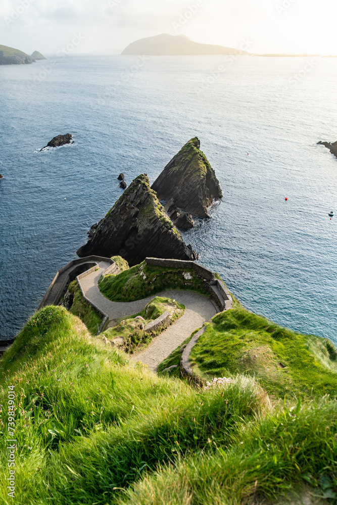 Dunquin or Dun Chaoin pier, Ireland's Sheep Highway. Narrow pathway winding down to the pier ...