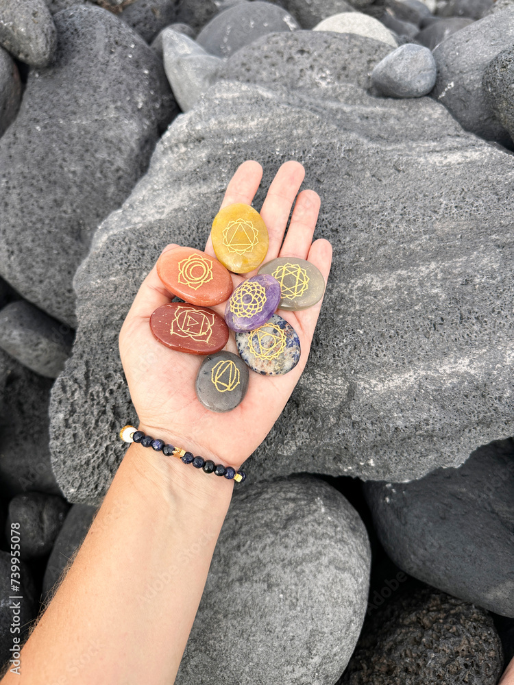 Hand holding chakra healing crystals. Witchcraft, herbal medicine and ...
