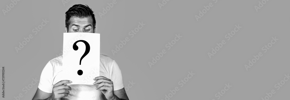 Man holding a question mark in front of his head, psychology concept ...
