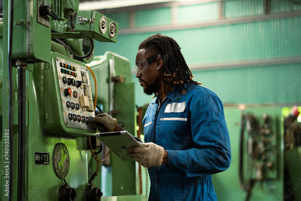 Black male mechanical engineer working at metal lathe factory Machine ...