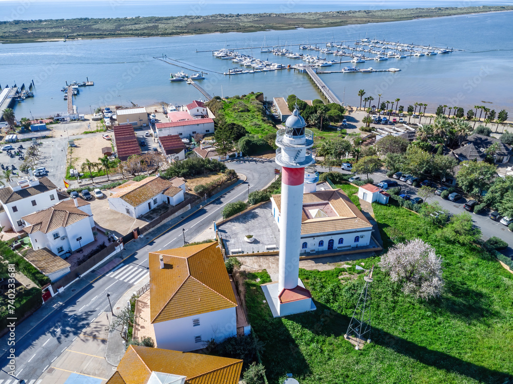 Aerial view of Lighthouse tower in the beach village El Rompido, in the ...