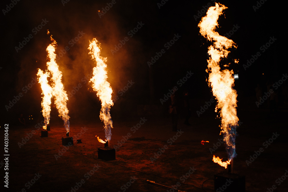 People dance a passionate dance with a fiery spinning wheel in hand ...