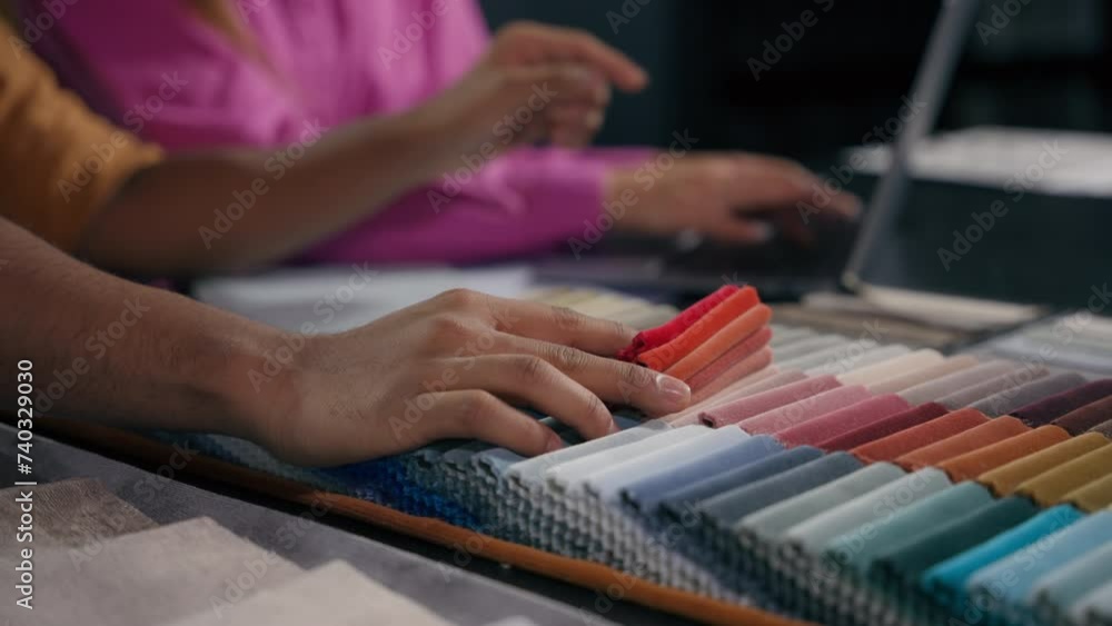 Close up details woman assistant and man designer choosing color fabric ...