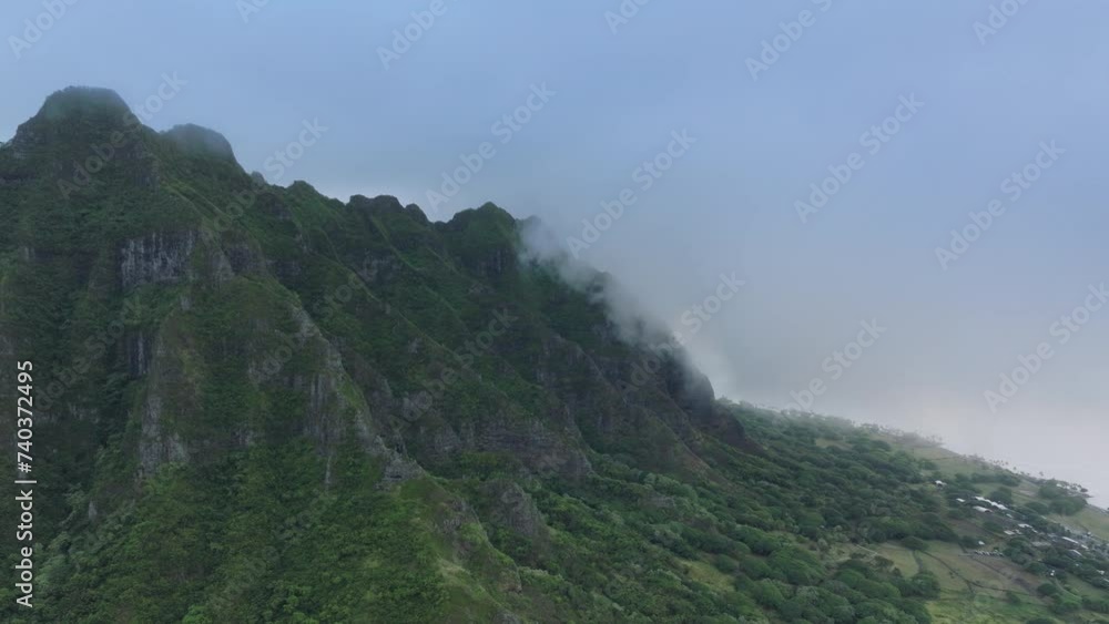 Rain streaked cliffs cast dramatic silhouette in Jurassic park scene ...