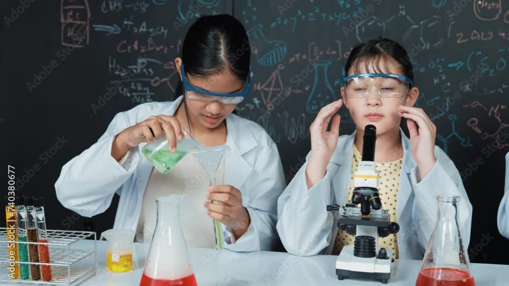 Young high school student doing experiment by pouring sample in test ...