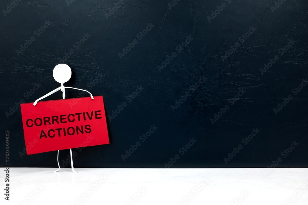 Stick figure holding corrective action placard in black background ...