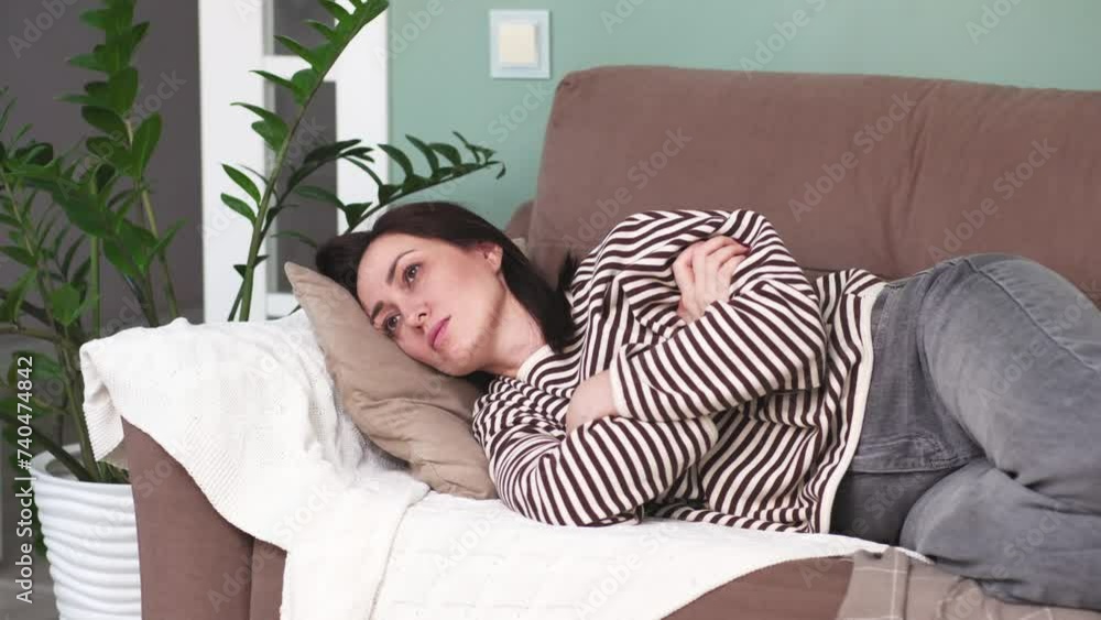 Exhausted or bored young sleepy woman lying on sofa. Apathetic tired ...