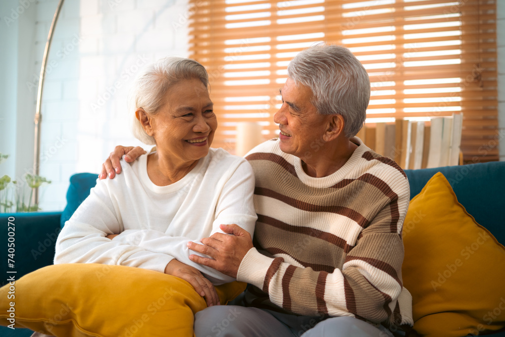Sweet older couple enjoys quiet time together, seated comfortably on ...