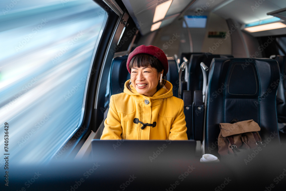 Beautiful asian woman commuting to work by high speed train. Enjoying ...