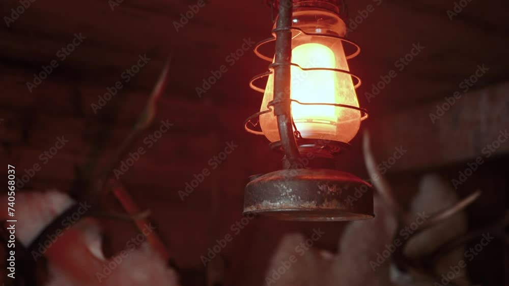Deer antlers hang on the wall with an ax and other metal weapons in the ...