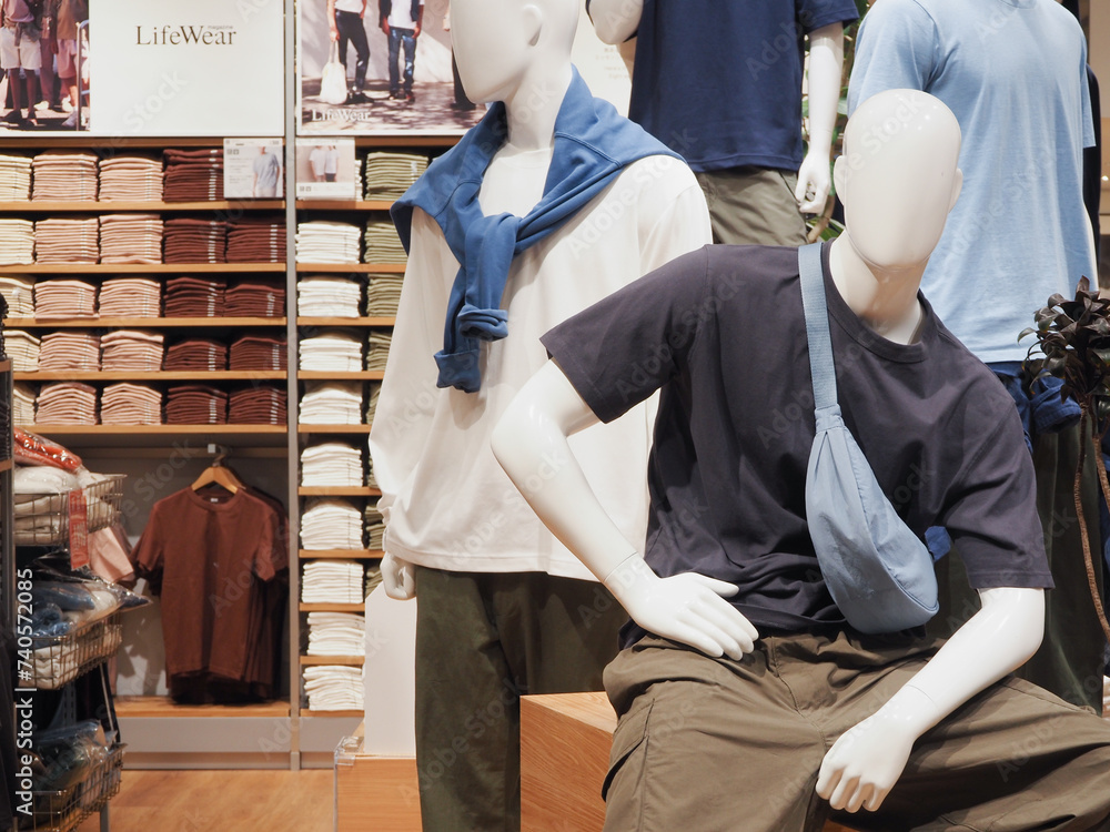 TOKYO, JAPAN - February 16, 2024: Display of clothes and mini round ...