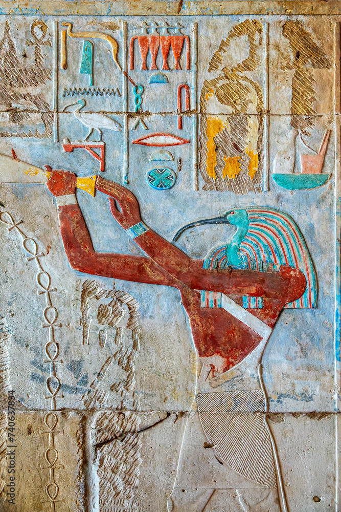 Carving with colorful hieroglyphs and Thoth with a ibis head, interior ...