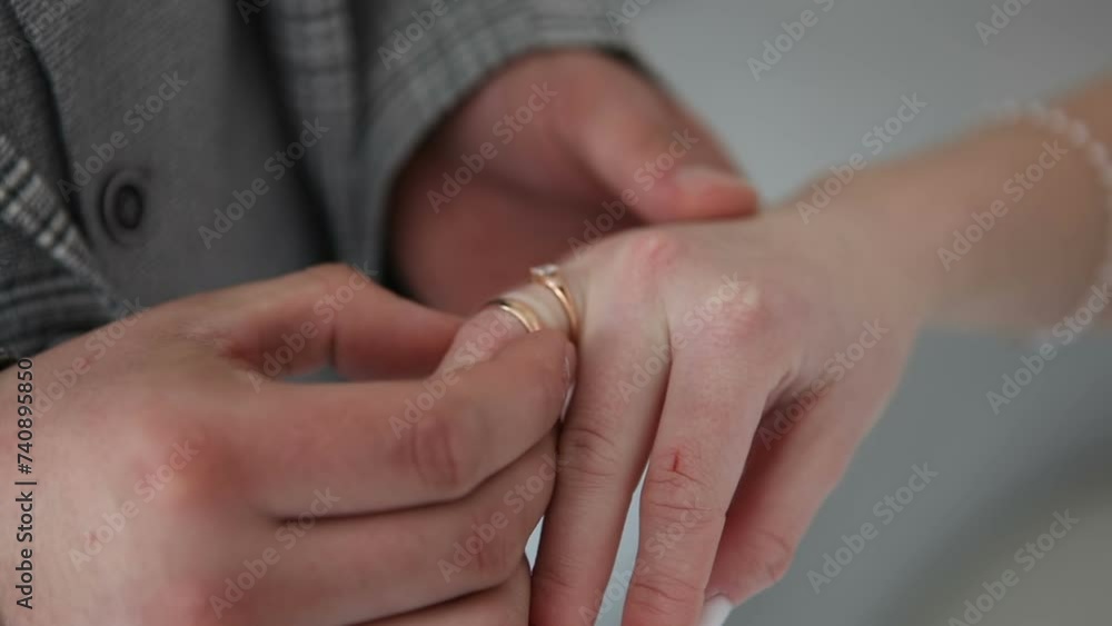 The bride and groom take turns putting wedding rings on each other ...