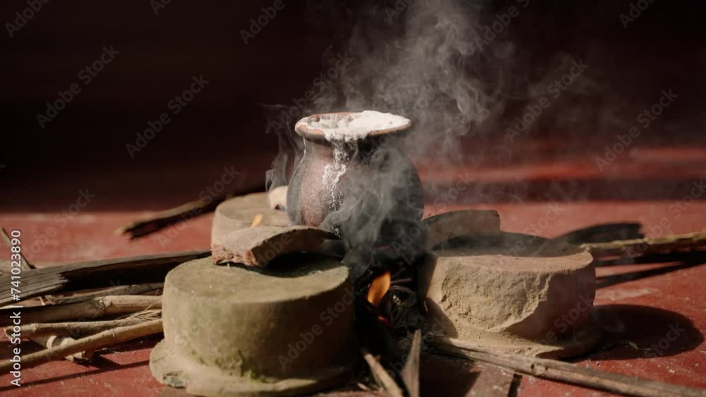 Sri Lankan housewife performs traditional milk boiling ritual over open ...