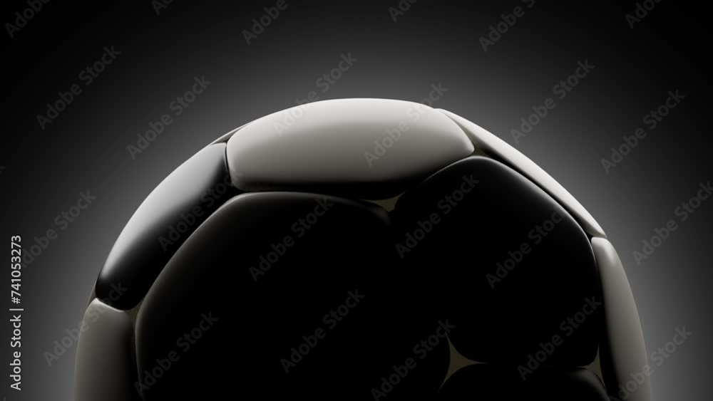 A graphically depicted soccer ball is rotating on a uniform background ...