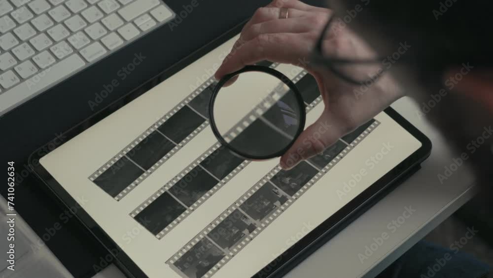 Vidéo Stock A photographer uses a magnifying glass for a detailed ...