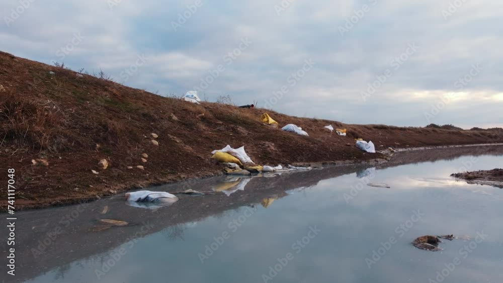The edges of the irrigation canals are full of discarded agricultural ...