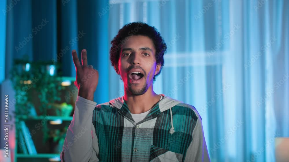 enthusiastic young black man impressed by information heard, watching ...