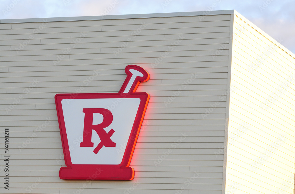 An exterior view shows a white and red medical prescription Rx symbol ...