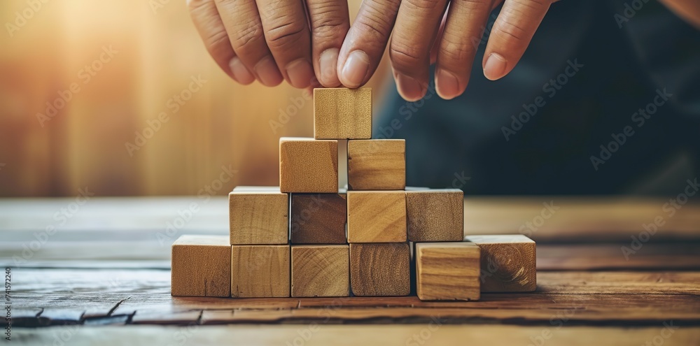 Strategic Formation: Hands Expertly Arrange Wooden Blocks, Creating a ...