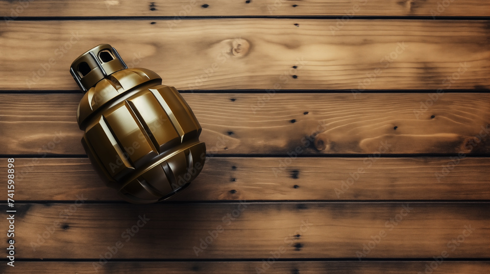 A golden grenade rests on a rustic wooden surface, casting a soft ...