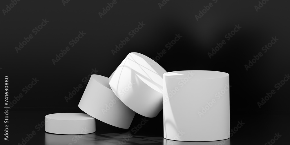 4 different size white cylinder Pedestal on black background with natural window light . Studio ...