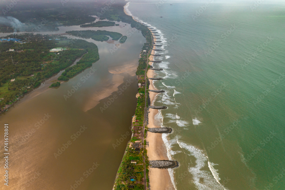 Aerial view of breakwater along a strip of land with Pithrody beach and ...
