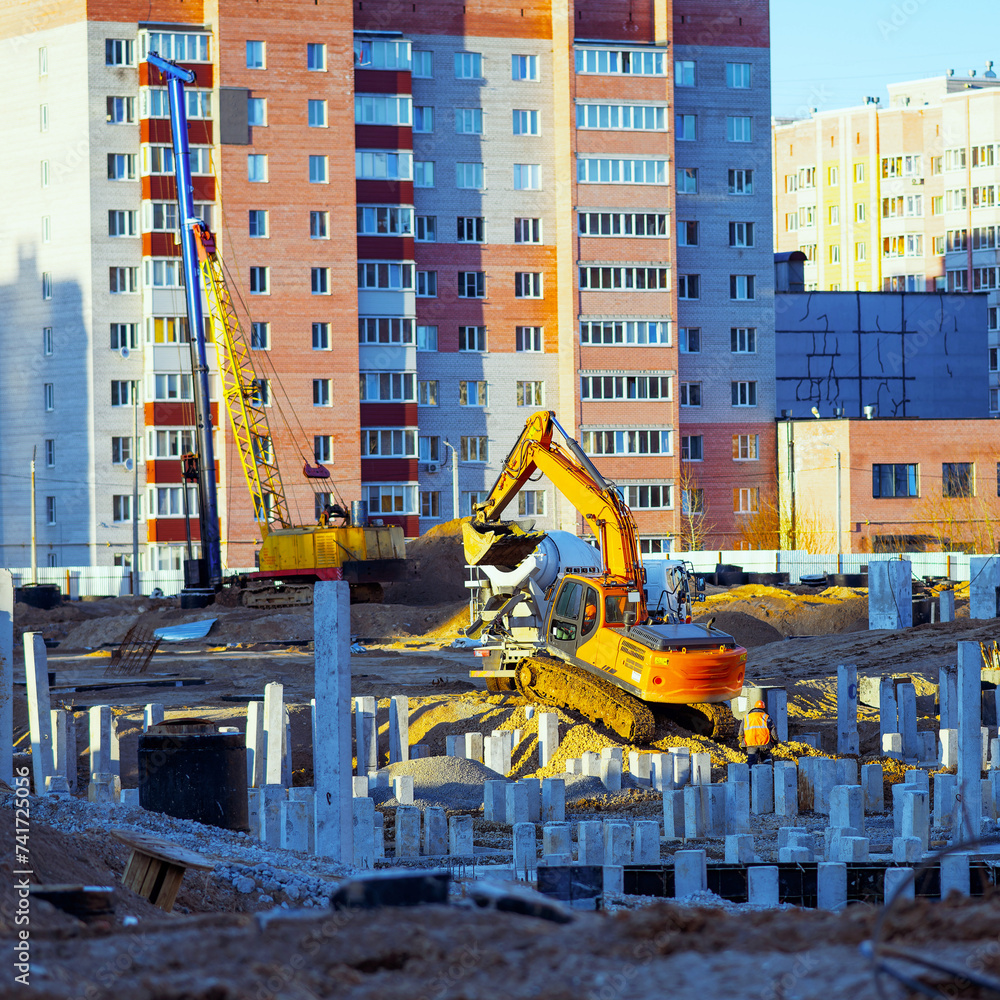 Excavator during earthmoving work at construction site.Construction of ...