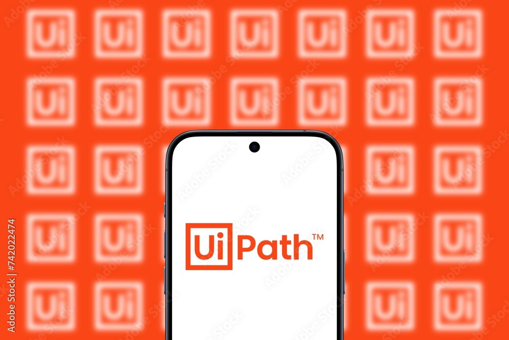 UiPath Logo is displayed on a modern smartphone, global software ...