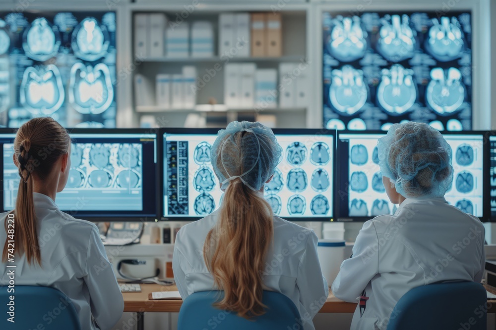 In a milky hospital office, female doctors in white coats with blue ...