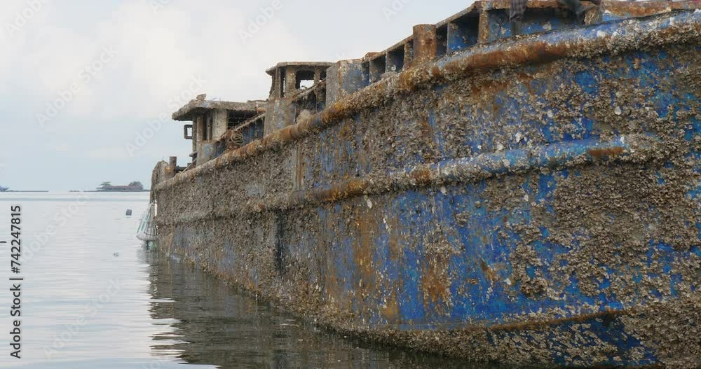 close up of the boat is heavily rusted, and barnacles and other marine ...
