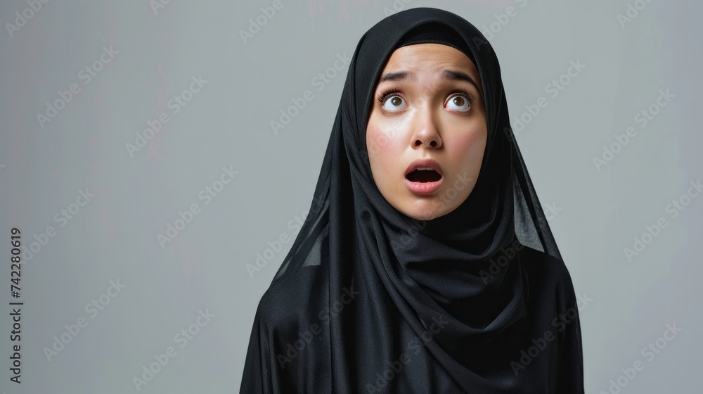 The candid expression of a young Malay Muslim woman with a shocked ...