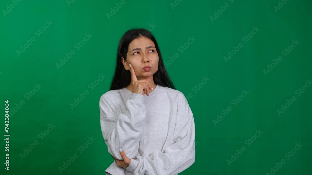 Reflective choices. Thoughtful woman in a studio portrait, exploring ...