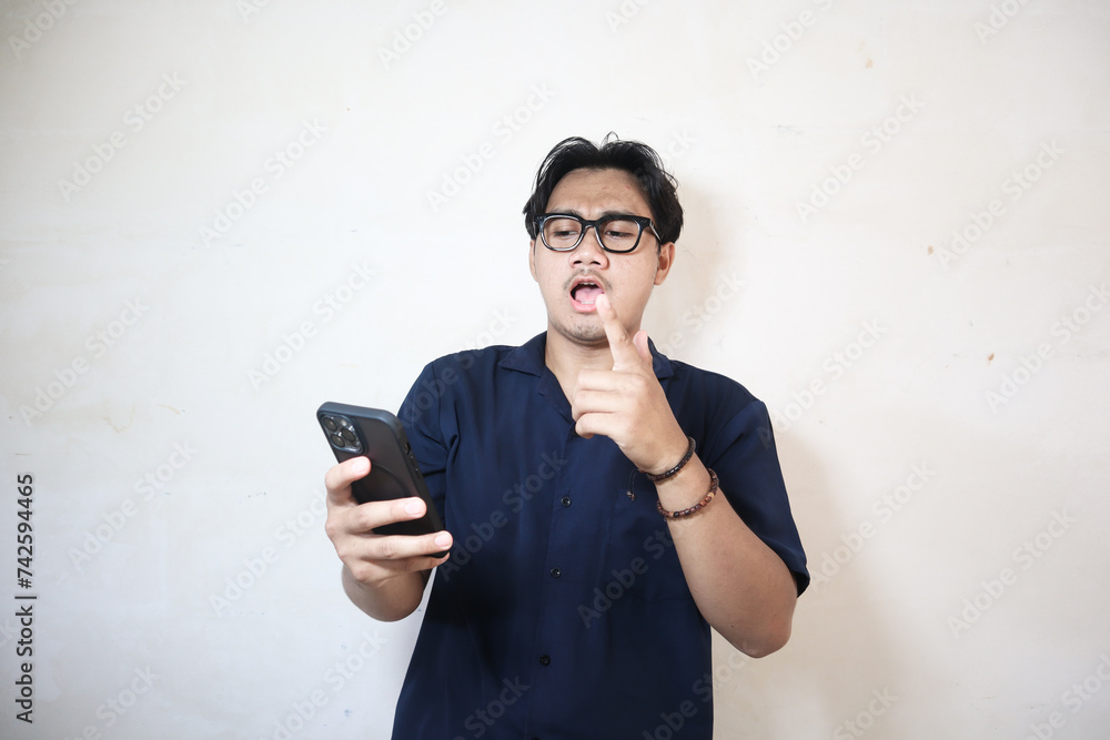 Wow face of Your Asian man shocked what he see in the smartphone on ...
