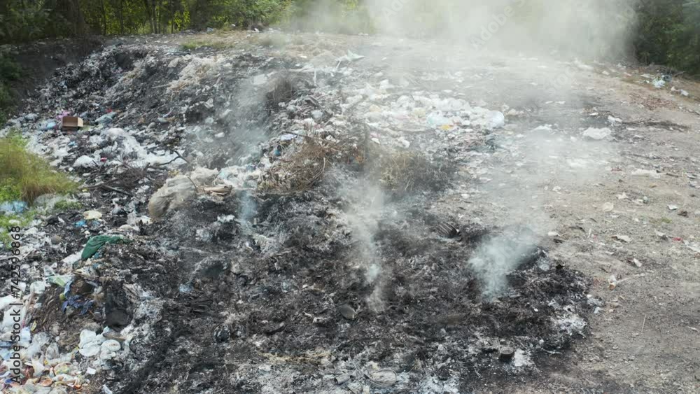 Garbage, fire burning and smoke in landfill. Also called trash, waste ...