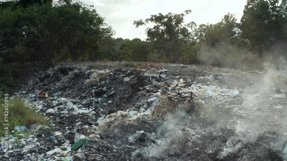 Garbage, fire burning and smoke in landfill. Also called trash, waste ...