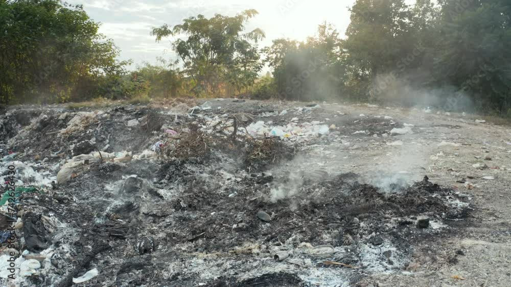 Garbage, fire burning and smoke in landfill. Also called trash, waste ...