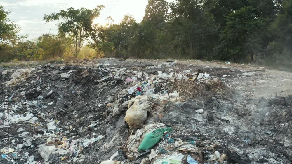 Garbage, fire burning and smoke in landfill. Also called trash, waste ...