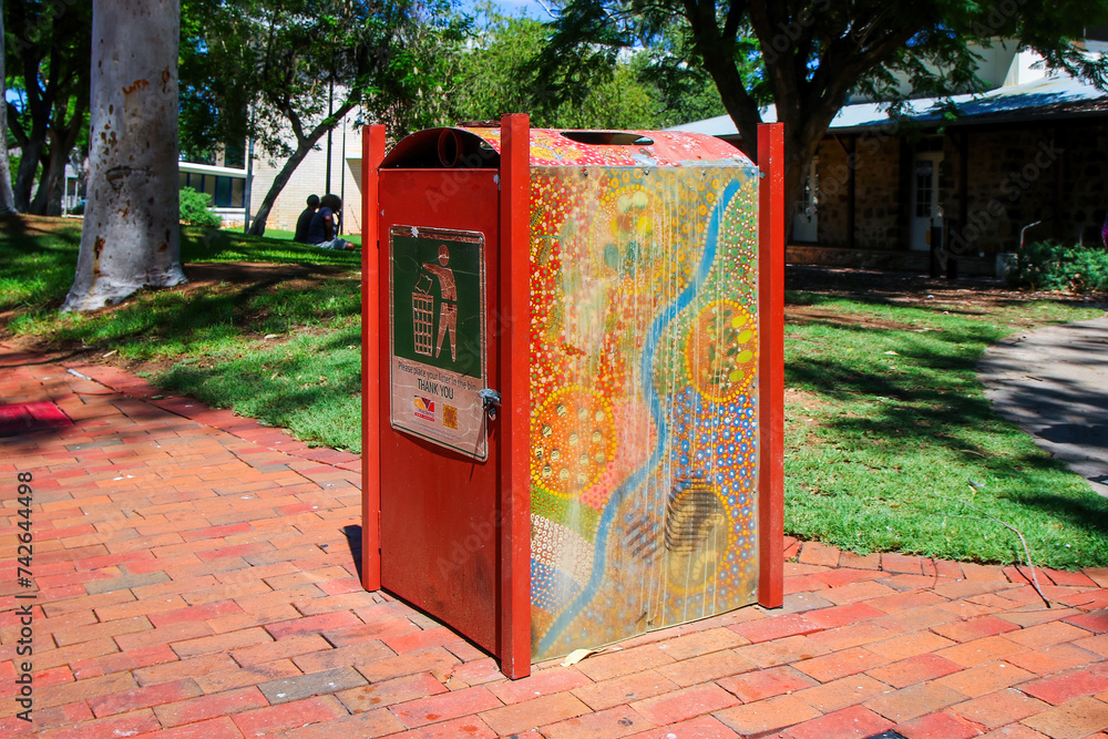 Public trash can decorated with dotted aboriginal painting on Todd Mall ...