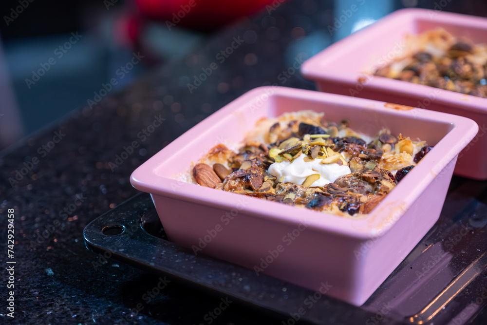 um ali is arabic sweet that made of puff pastry and nuts with milk and ...