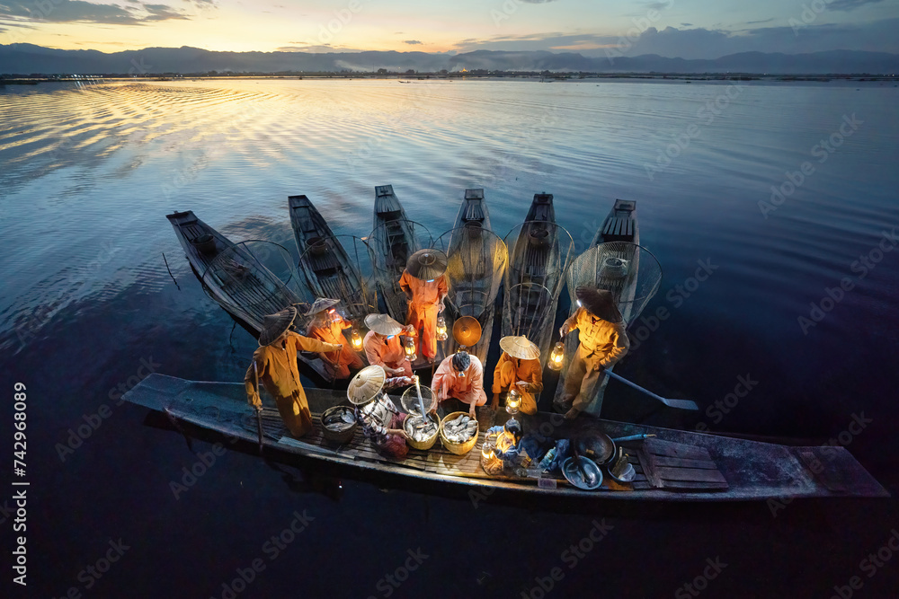 Burmese fisherman casting or throwing a net for catching freshwater ...