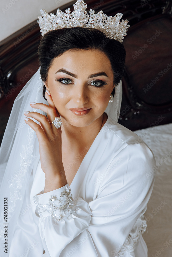 portrait of an incredibly beautiful girl bride in a white robe in the ...