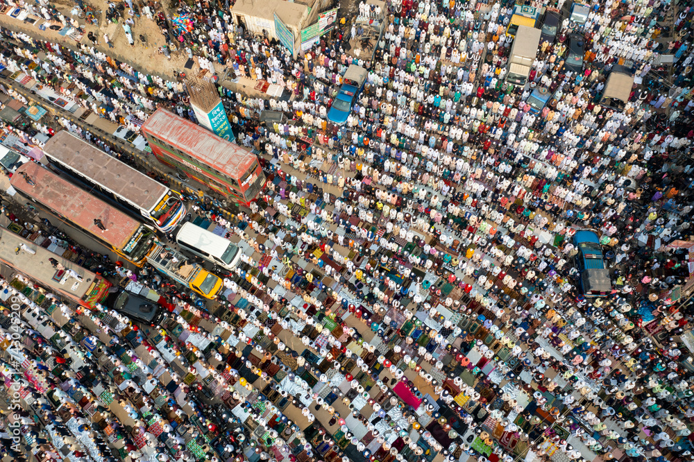 Aerial view of packed congregation of Muslim devotees praying and ...