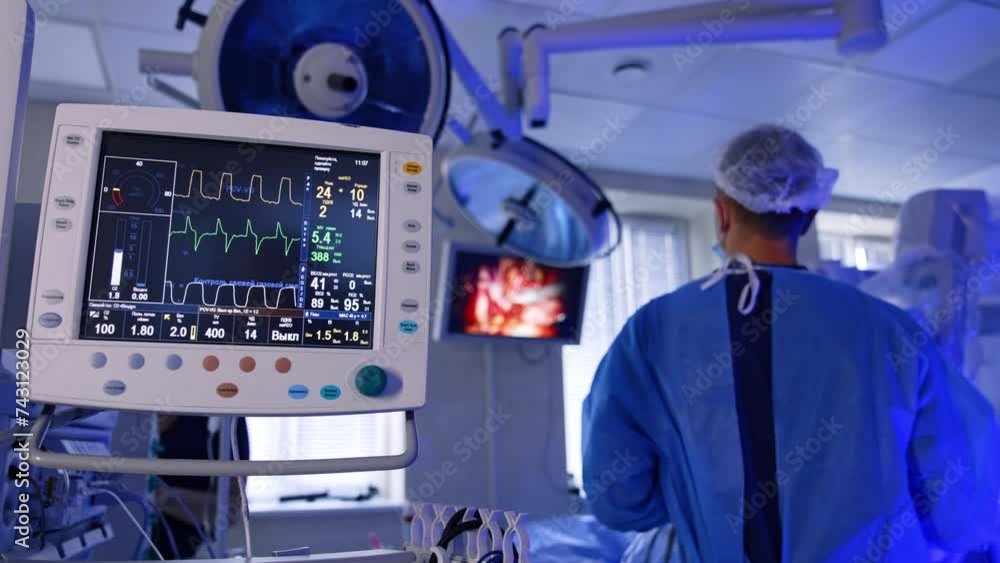 Screen with life signs of a patient under operation. Rear view of a ...