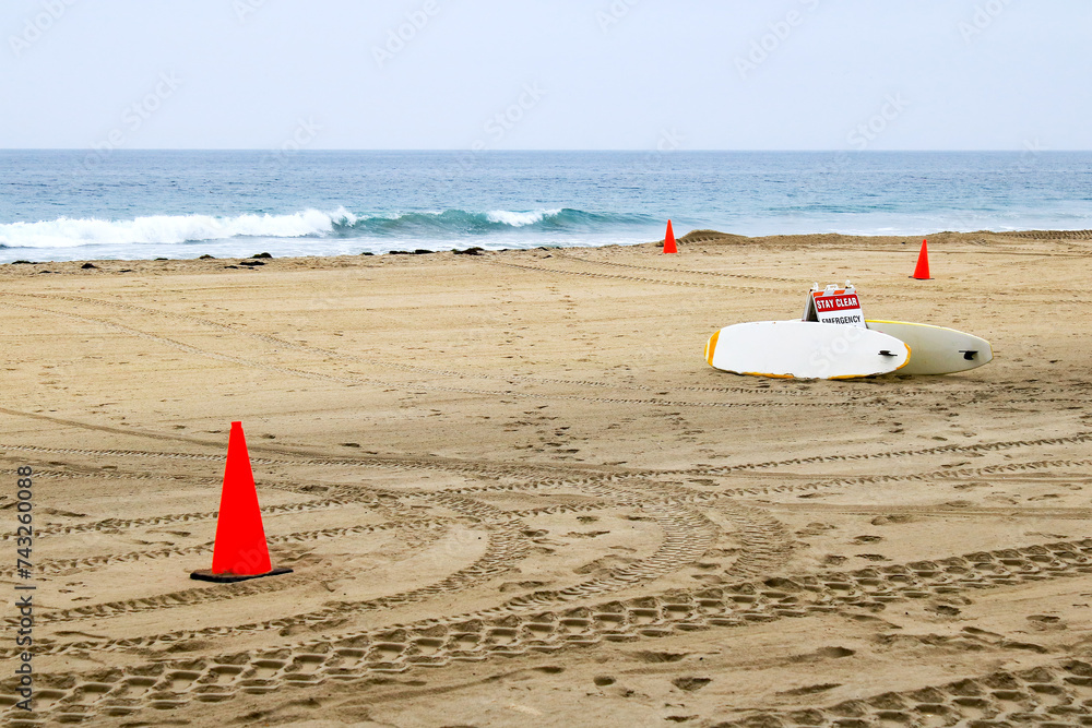 Access area to ocean for lifeguard personal marked with red cones ...