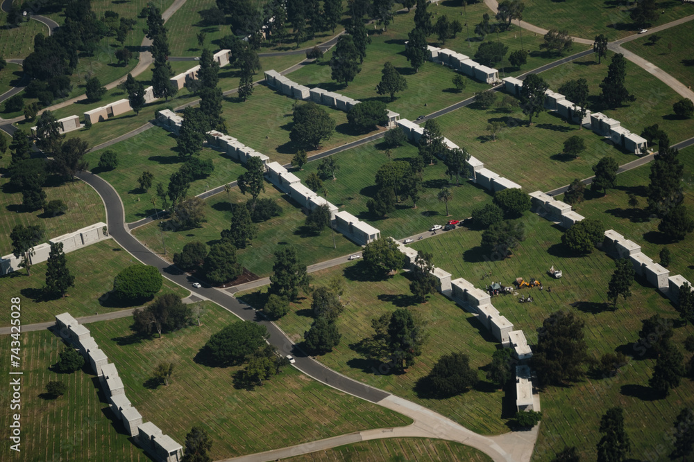 Aerial view of a cemetery, where grave stones span across a grassy lawn ...